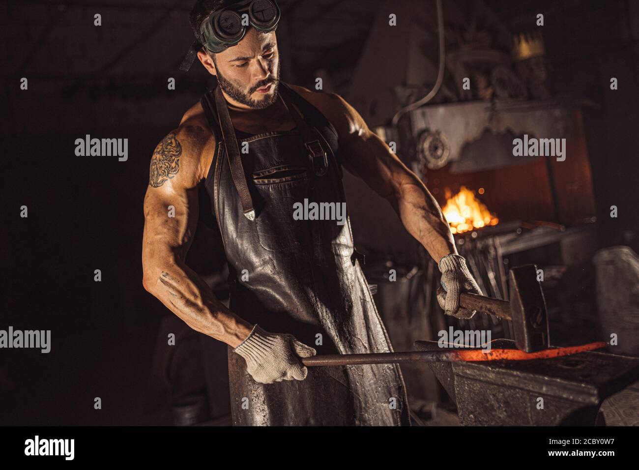Blacksmith workshop man holding metal hi-res stock photography and ...