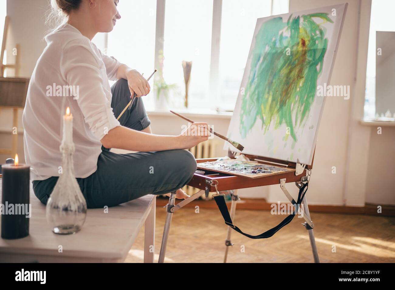 girl doing a painting. close up side view photo. close up side view ...