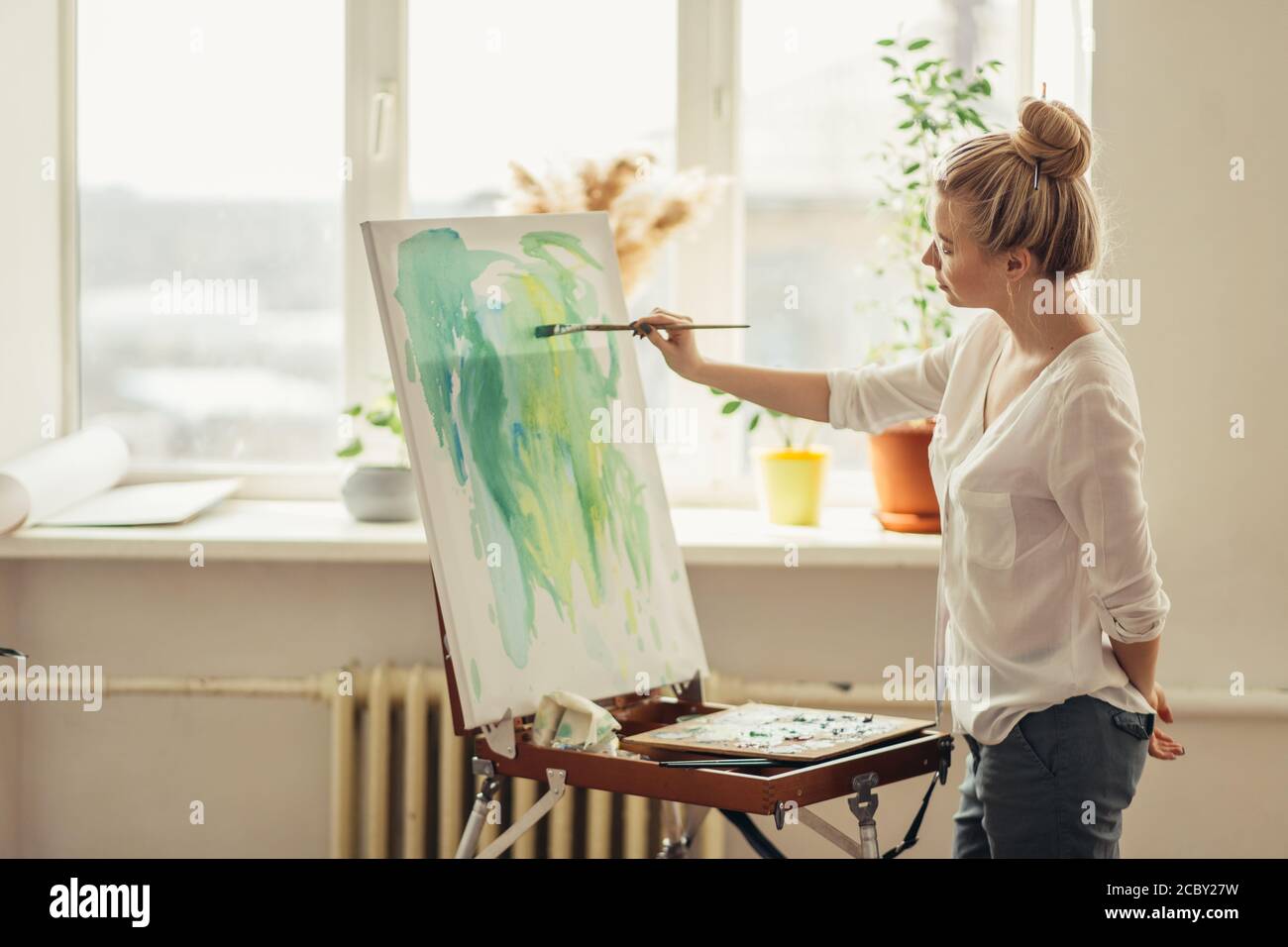 awesome woman applying paint on the paper, close up side view photo ...