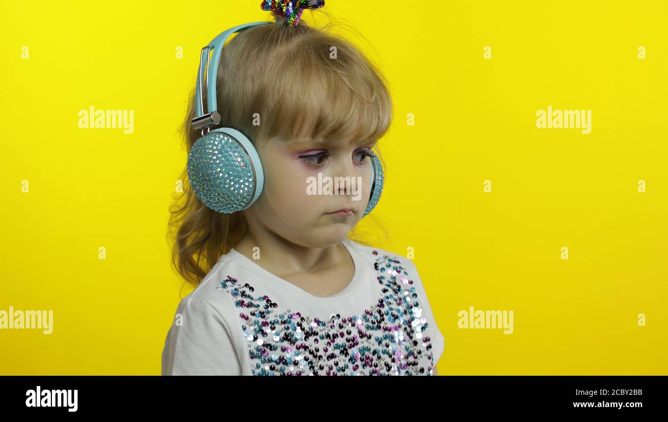 Bored lazy child looking at camera with indifference, listening to ...