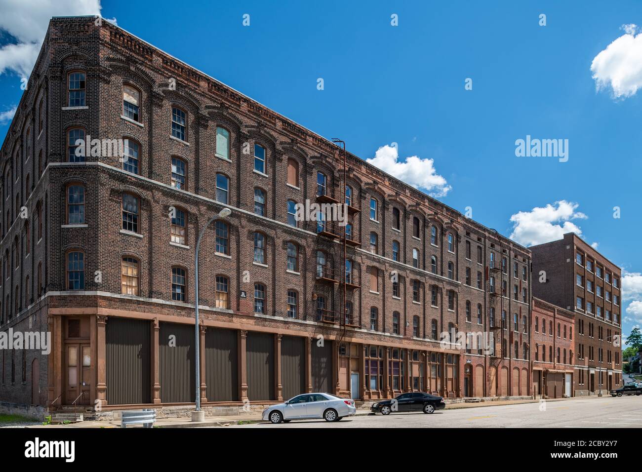 19th Century warehouse industrial buildings along railroad tracks in ...
