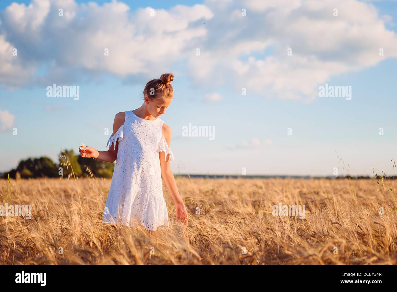 Happy cute girl in wheat field outdoors Stock Photo - Alamy