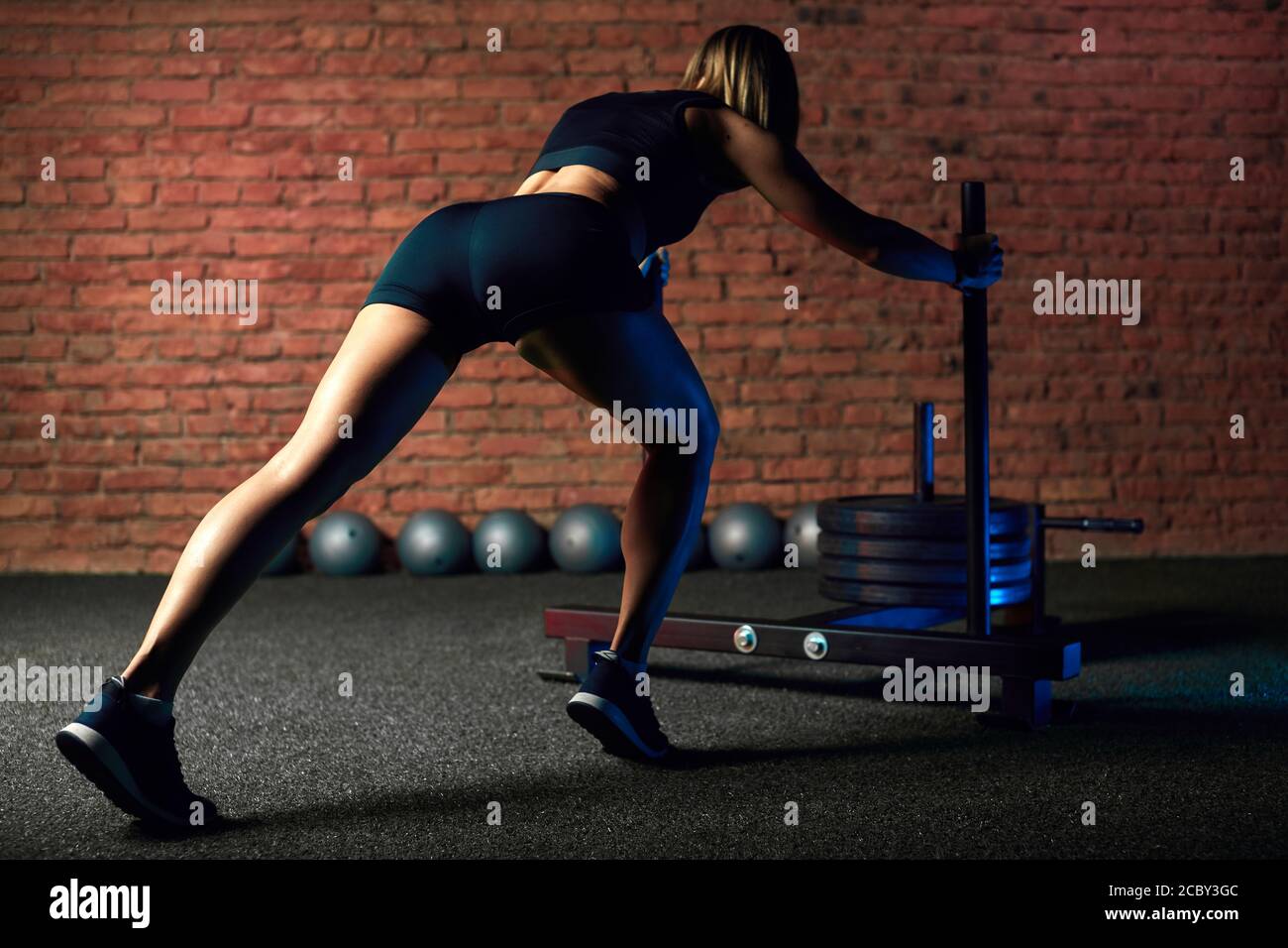 Woman exercise pushing against wall hi-res stock photography and images ...