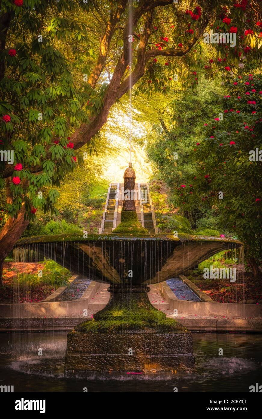 A fountain at Holker Hall under the Rhododendron trees, taken in summer ...