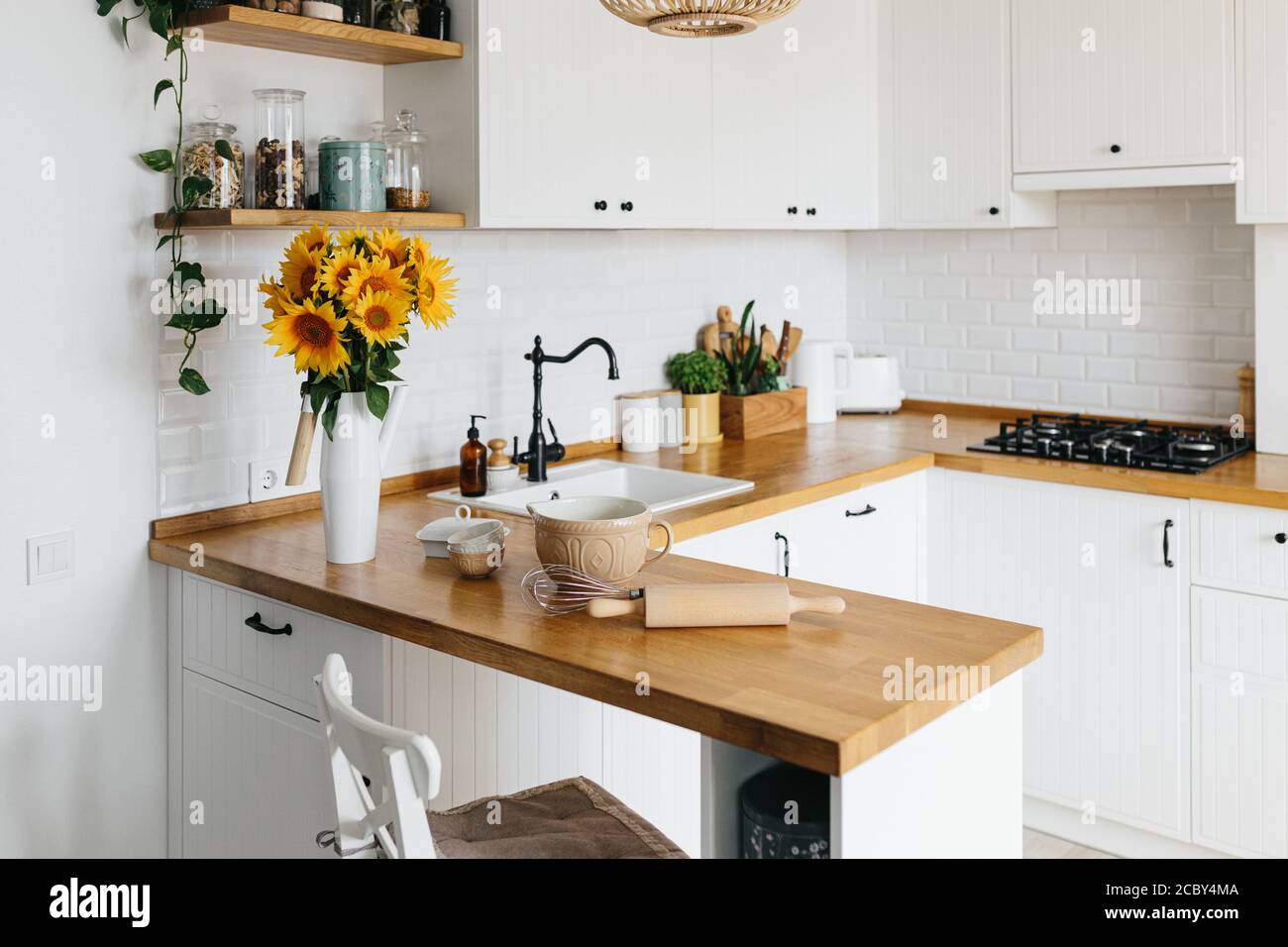 Dishes and utensils on kitchen table, ready to cook. white simple ...