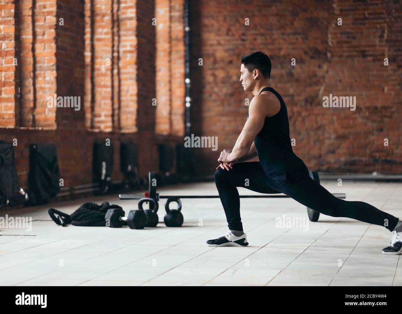 strong ambitious Asian guy is warming up before workout,lifestyle ...