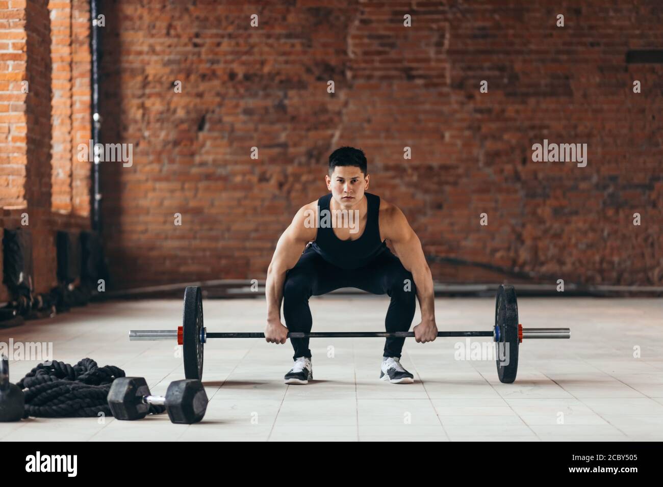 asian man is learning to lift weight. full length photo. motivation ...