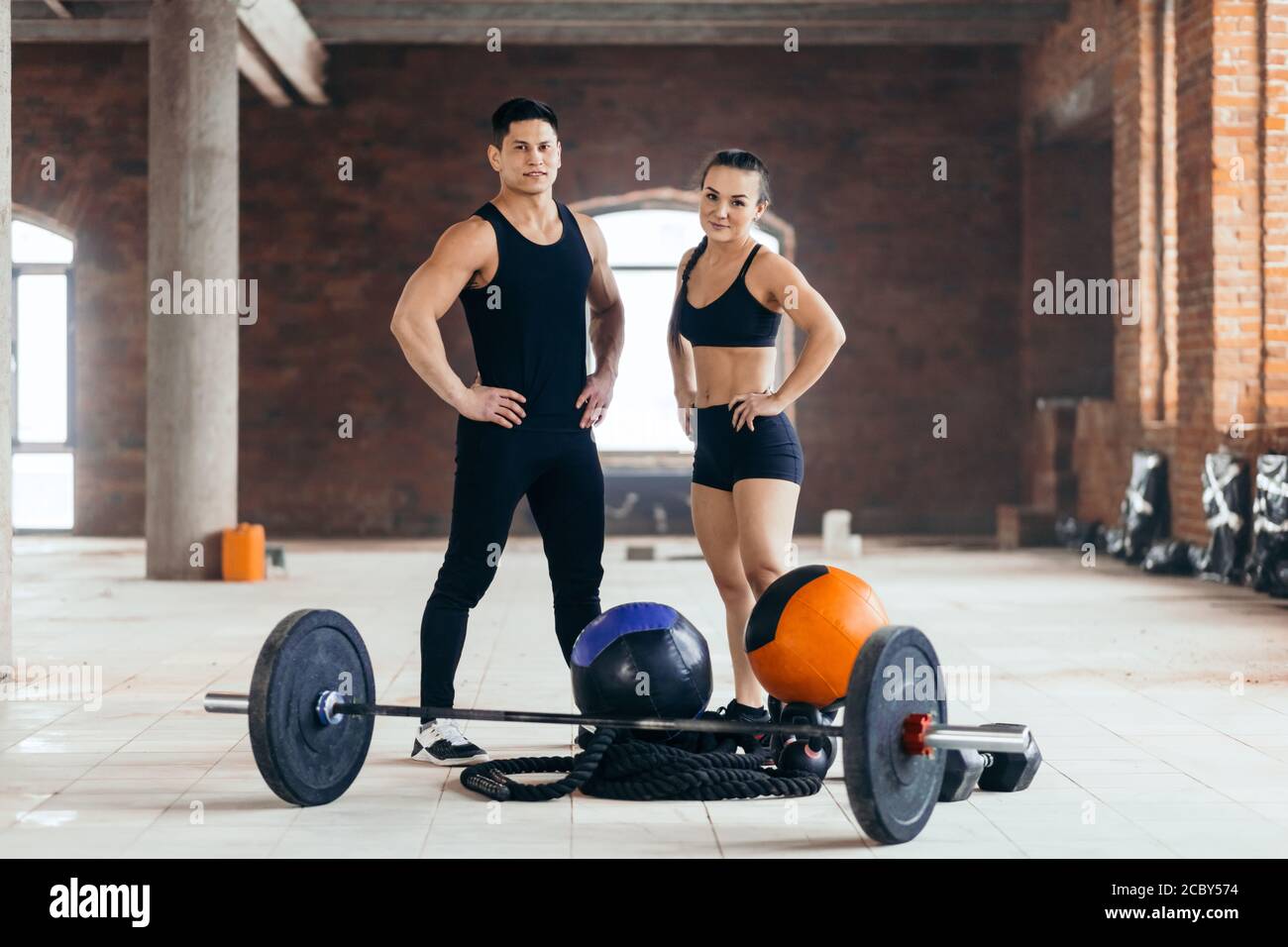 full length photo. cheerful athletes looking at the camera in the room ...