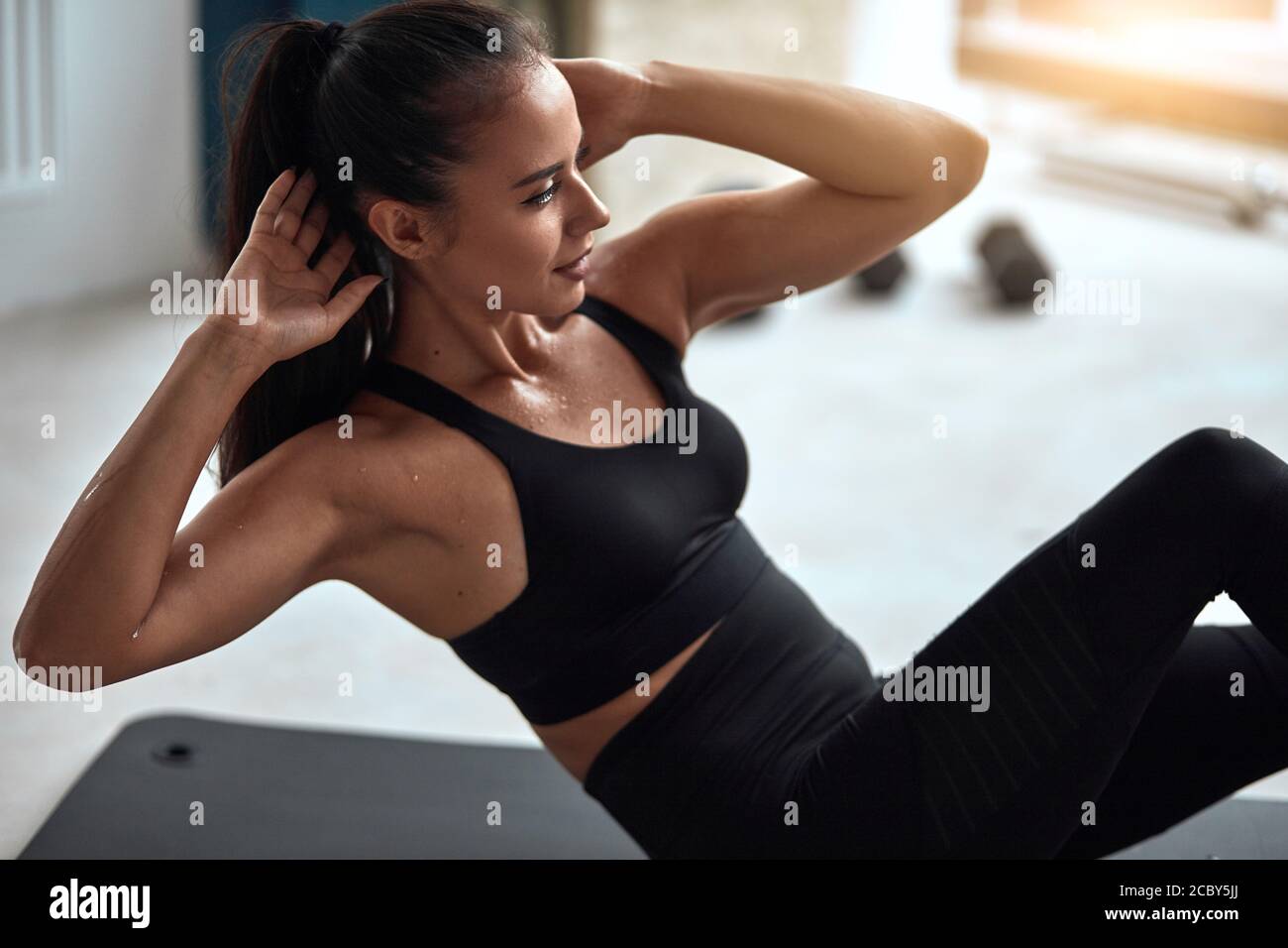 Attractive fit female pump press in gym. Fitness girl in black ...