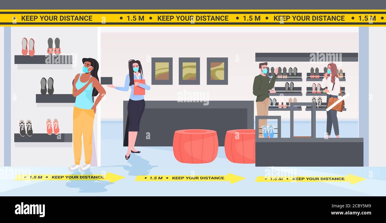 mix race customers in masks choosing clothes keeping distance ...