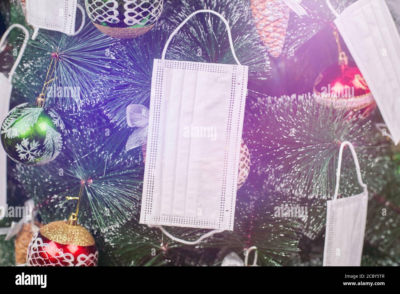 Christmas tree decorated with face masks and toys. Merry Christmas in ...