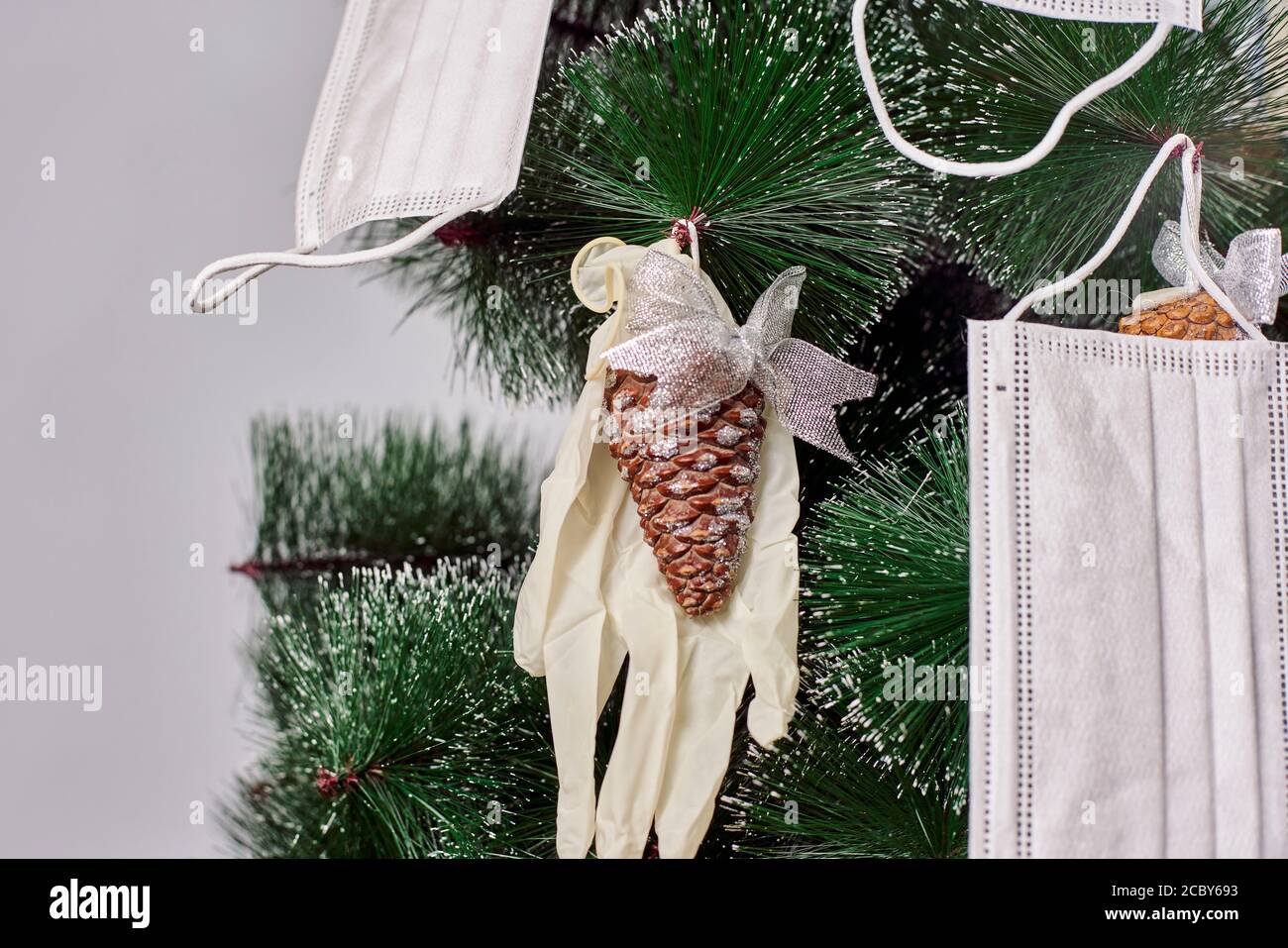 The new normal. Traditional Christmas tree with decorative ornate and ...