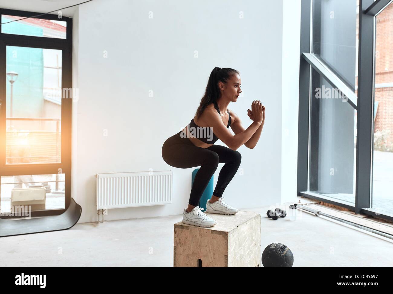 Box jumping at crossfit style in gym, box jump performing of young fit ...