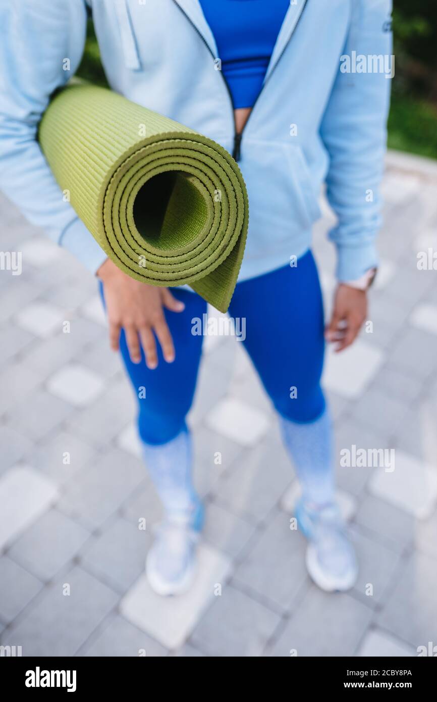 Close-up woman holding roll fitness after working Stock Photo - Alamy