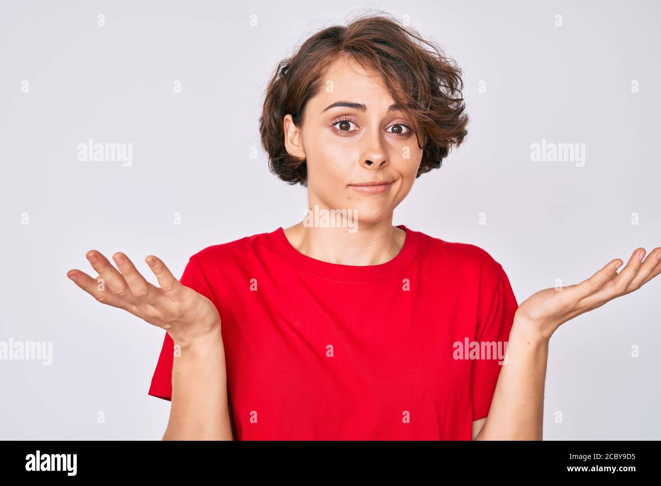 Young hispanic woman wearing casual clothes clueless and confused with ...