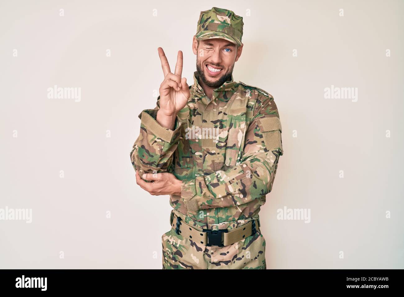 Young caucasian man wearing camouflage army uniform smiling with happy ...