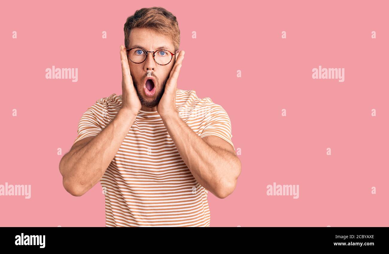 Young caucasian man wearing casual clothes and glasses afraid and ...