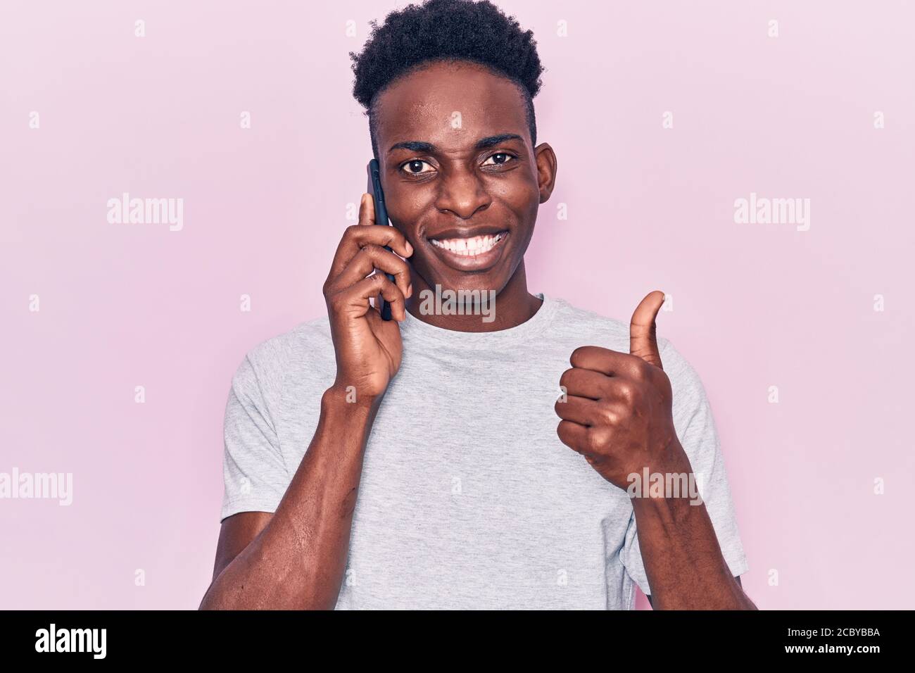 Young african american man having conversation talking on the ...