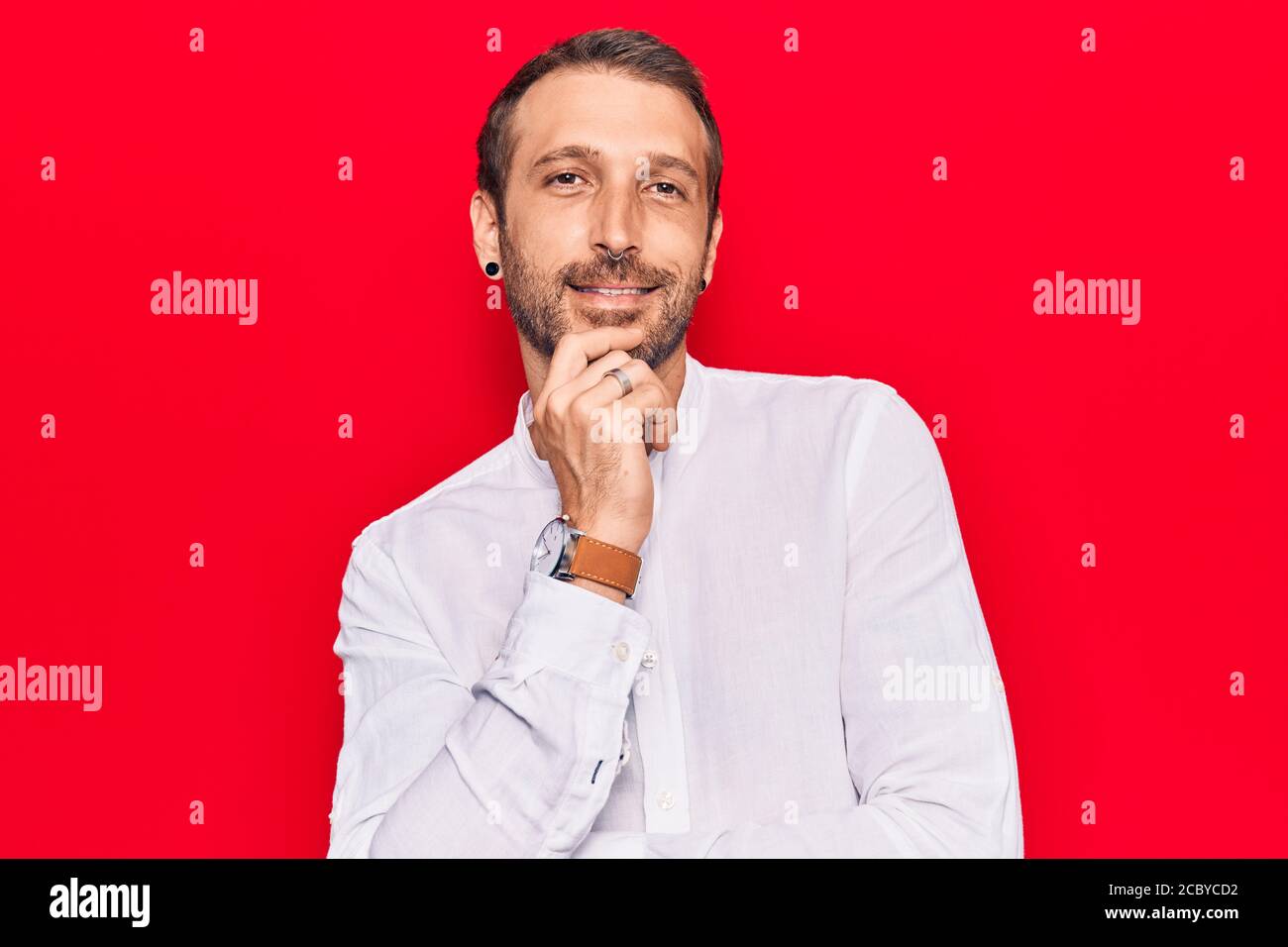 Young handsome man wearing casual clothes smiling looking confident at ...