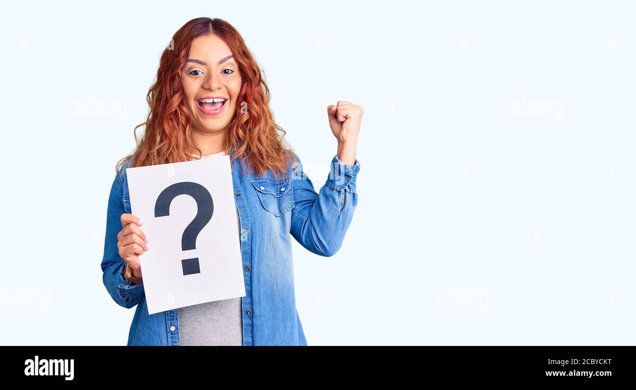 Young latin woman holding question mark screaming proud, celebrating ...
