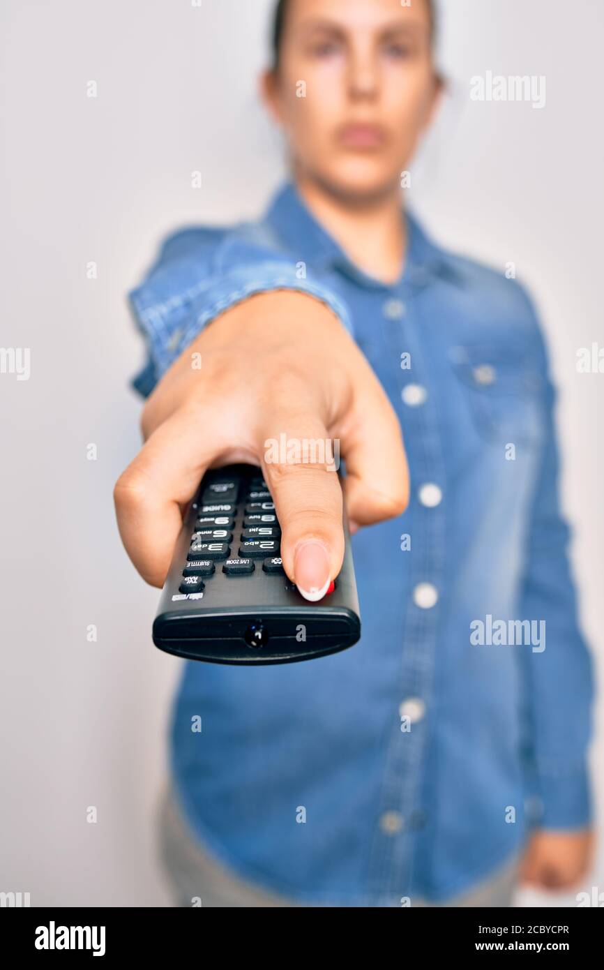 Woman turning off television holding tv remote control. Standing over ...