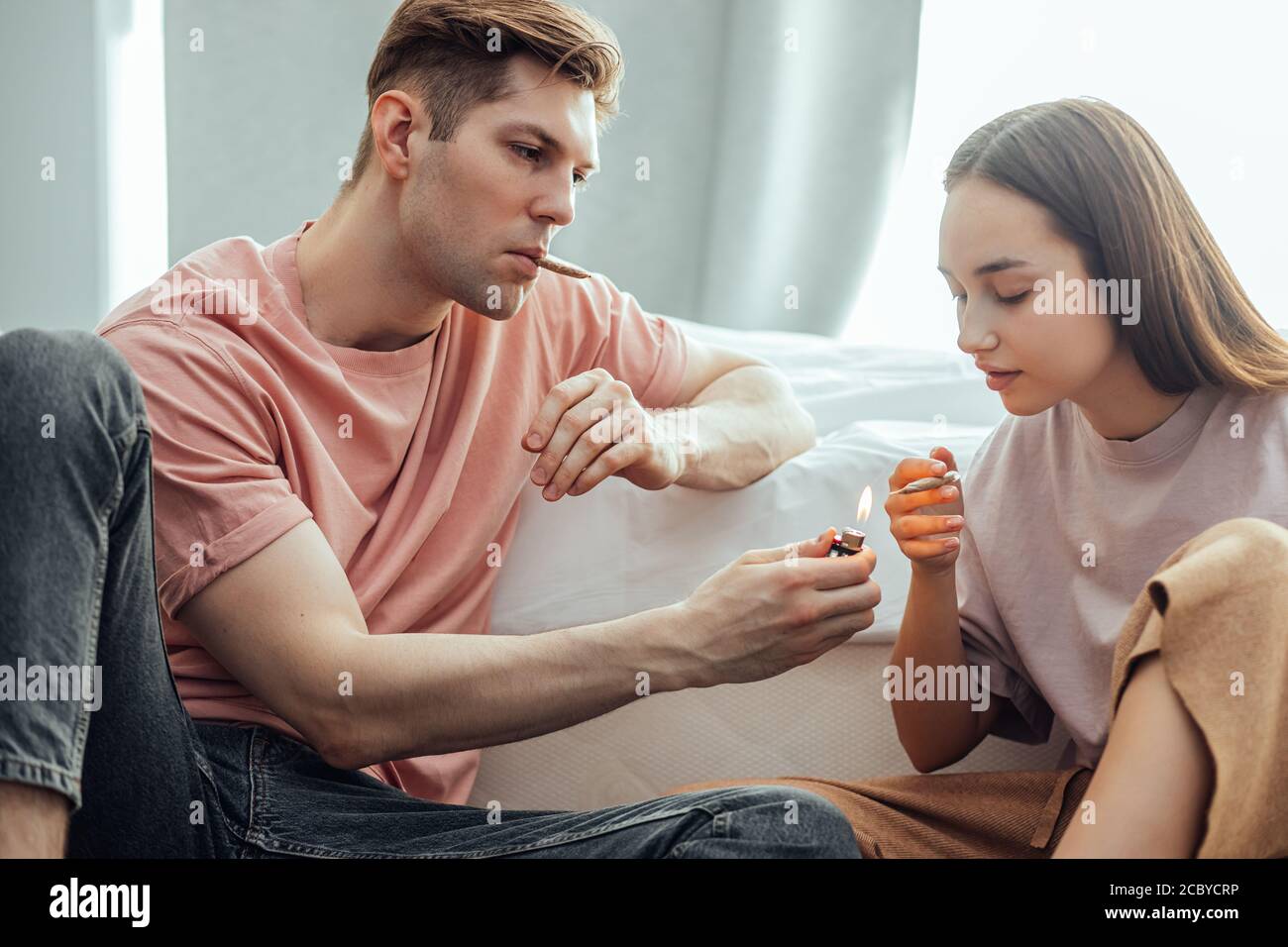 young caucasian man and woman using drugs at home, couple suffer from ...