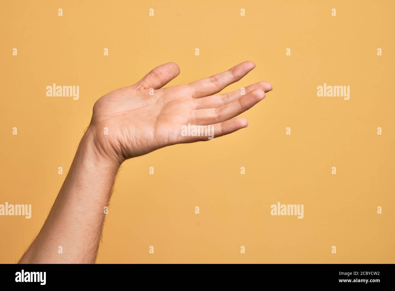 Hand of caucasian young man showing fingers over isolated yellow ...