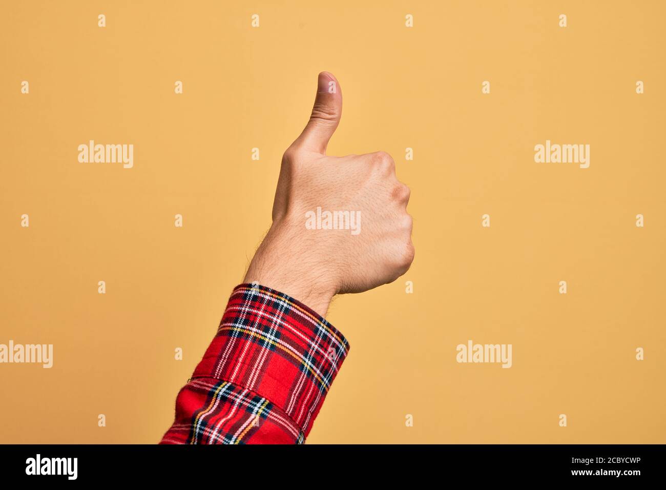 Hand of caucasian young man showing fingers over isolated yellow ...