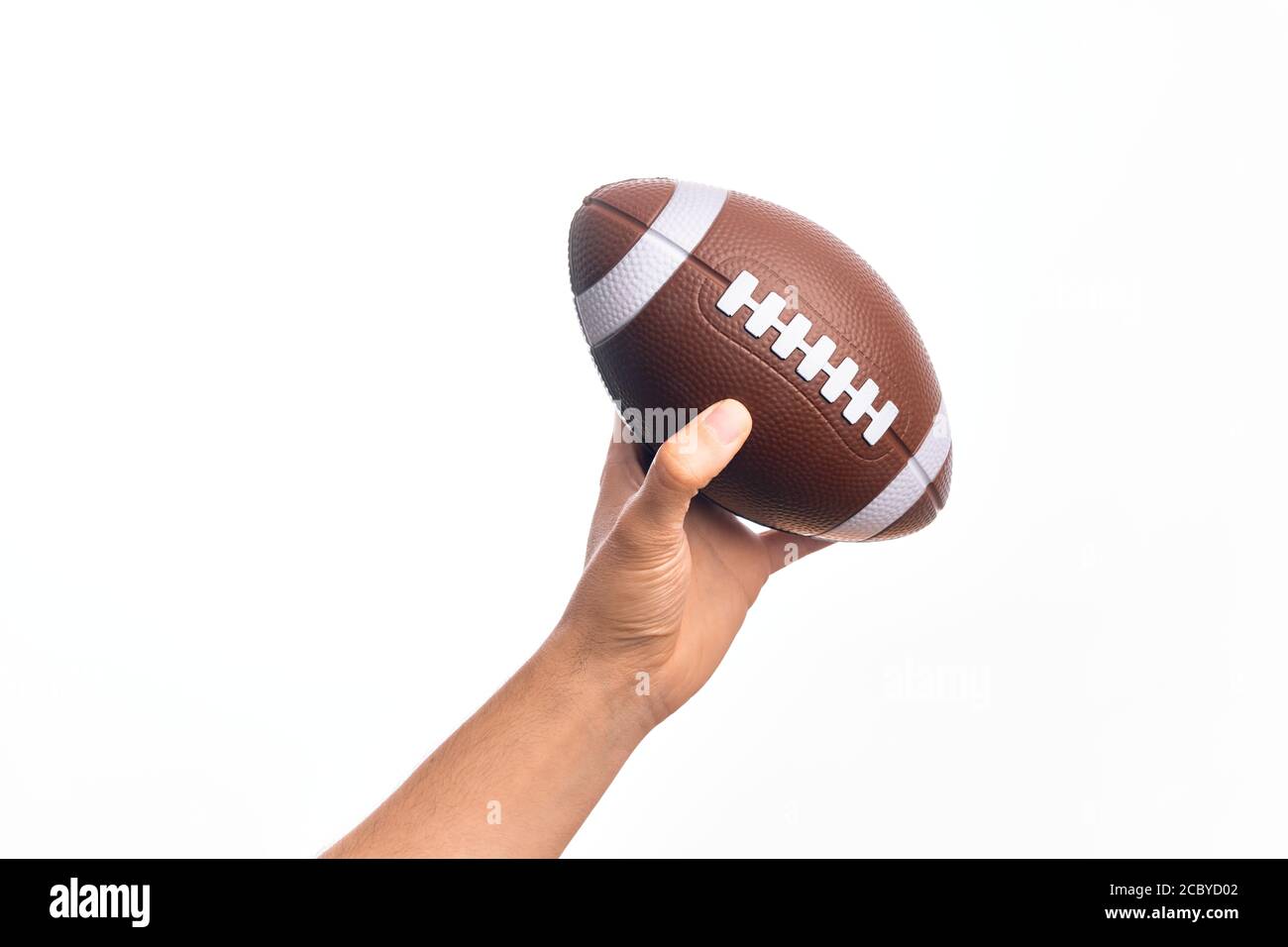 Hand of caucasian young sporty man holding football ball over isolated ...