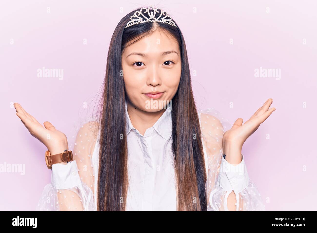Young beautiful chinese woman wearing princess crown clueless and ...