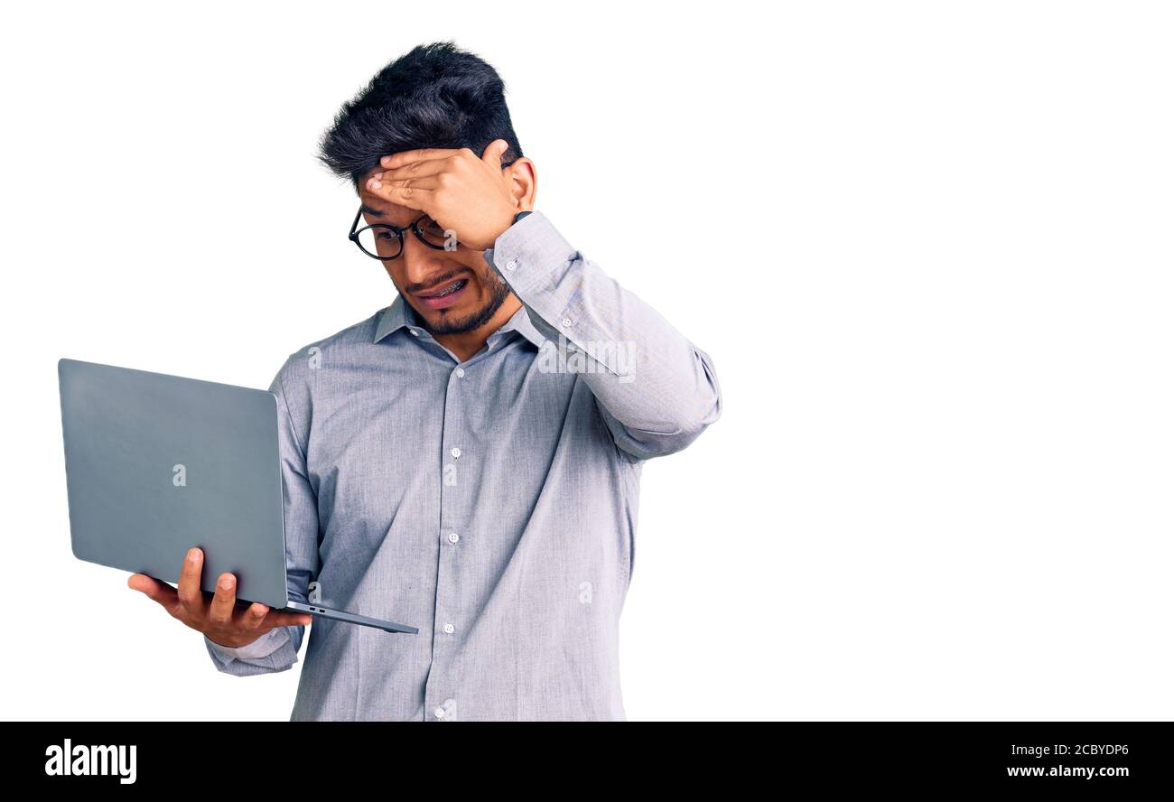 Handsome latin american young man working using computer laptop ...