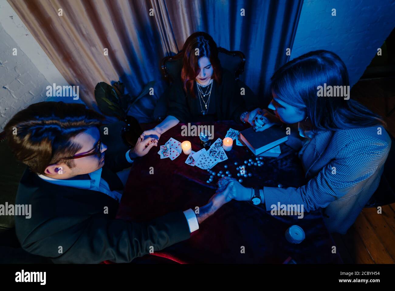 People hold hands of night at table with candles Stock Photo - Alamy