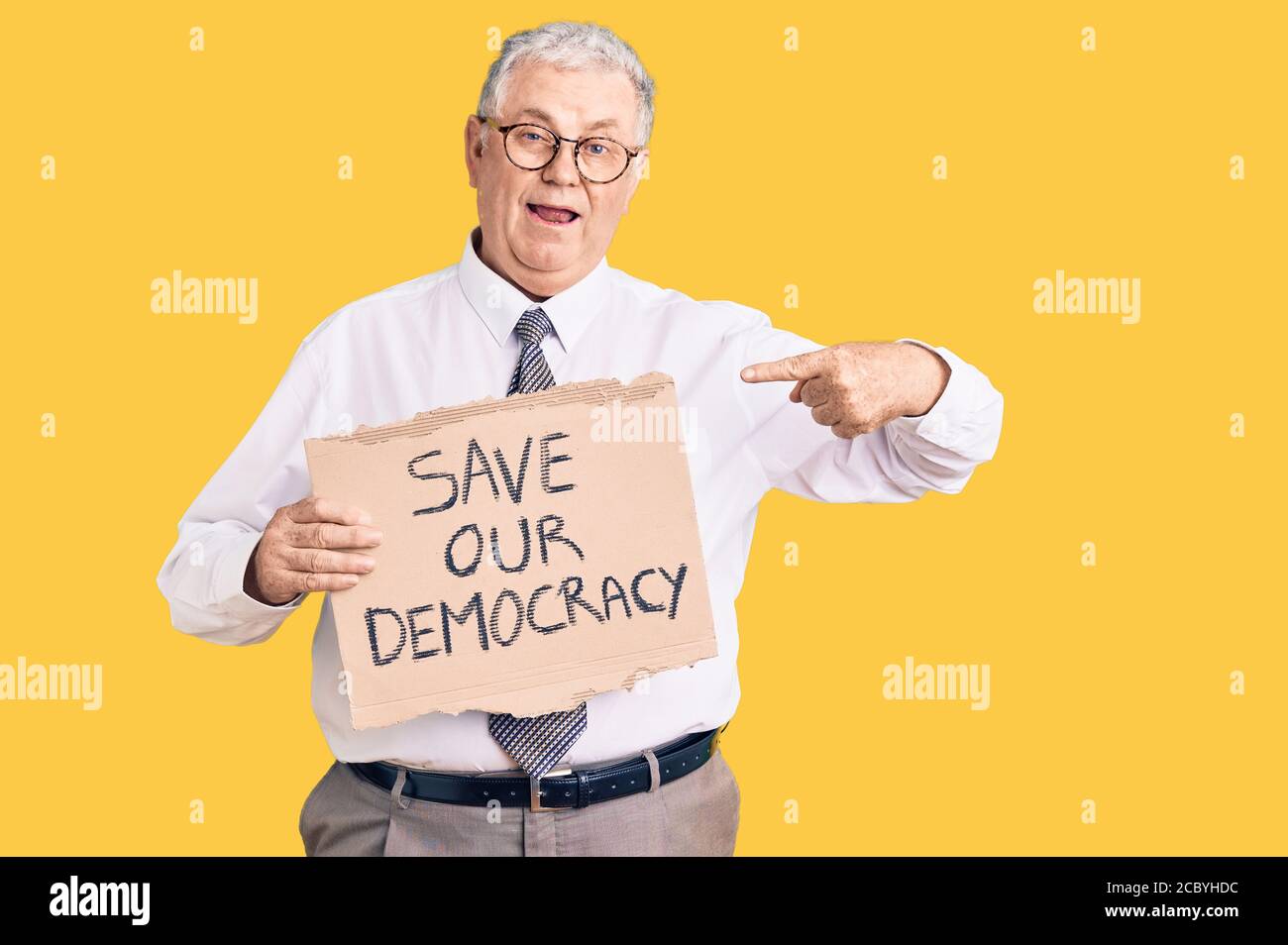 Senior grey-haired man wearing business clothes holding save our ...