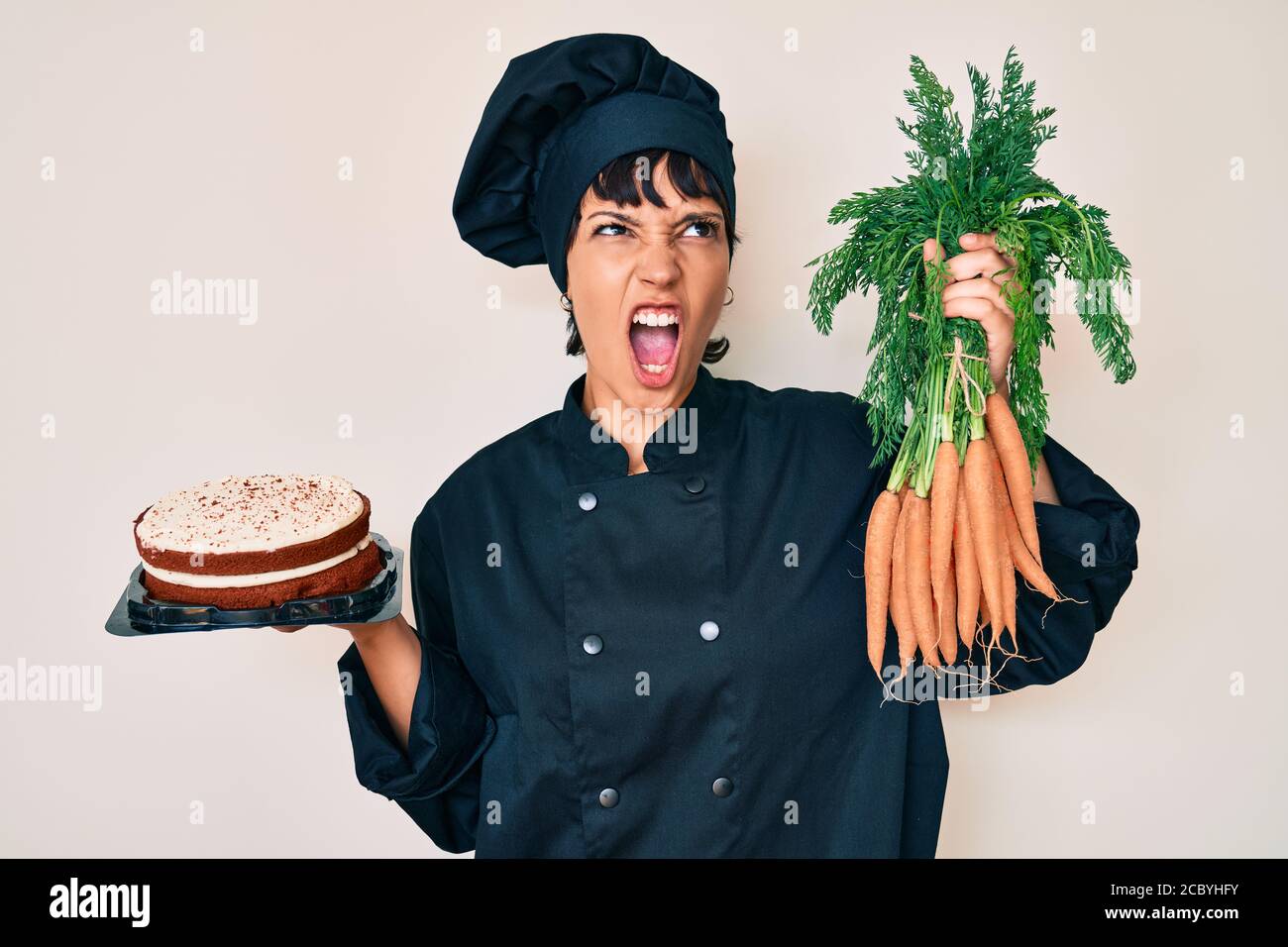 Beautiful brunettte woman chef cooking carrot cake angry and mad ...