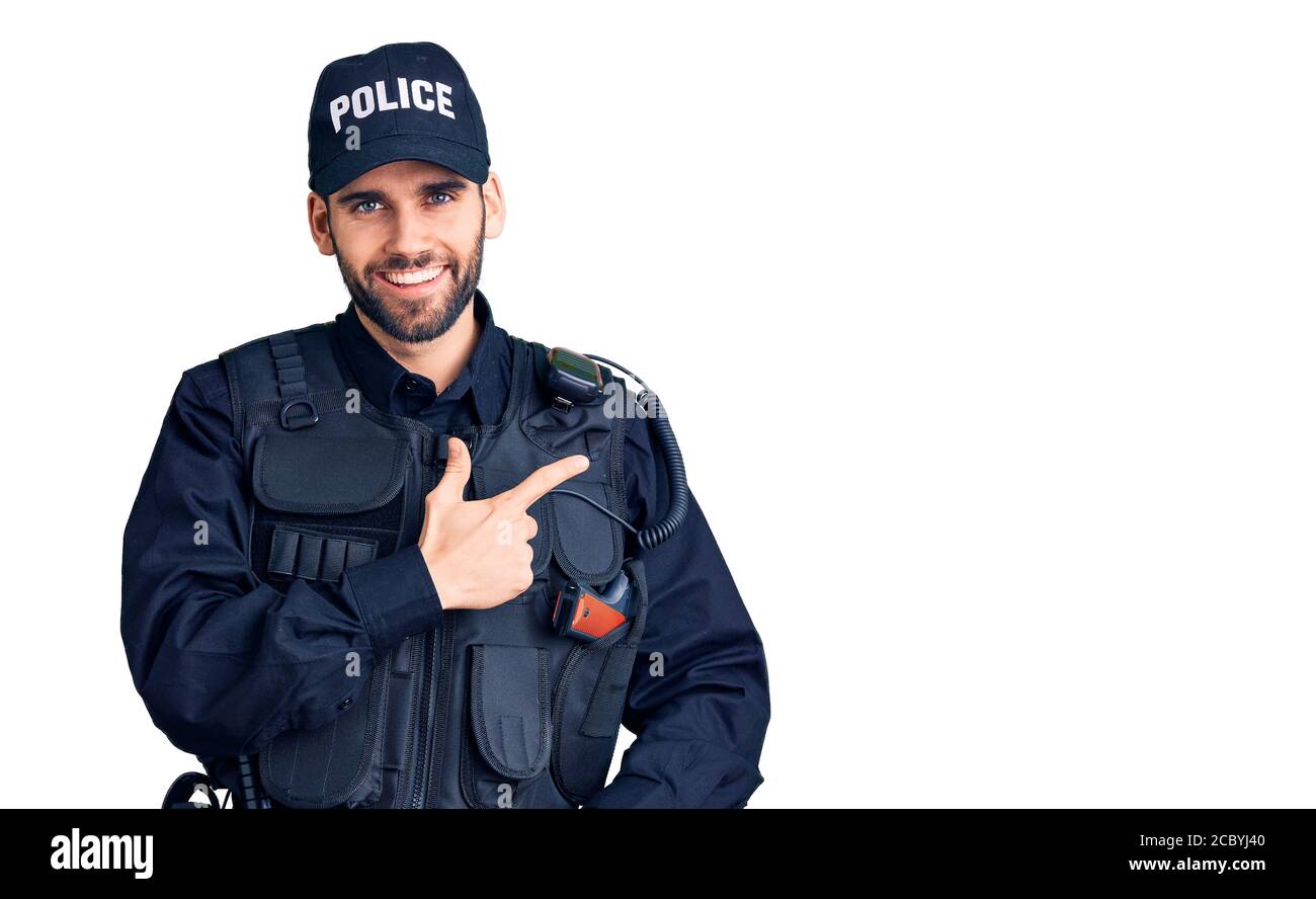 Young handsome man with beard wearing police uniform cheerful with a ...