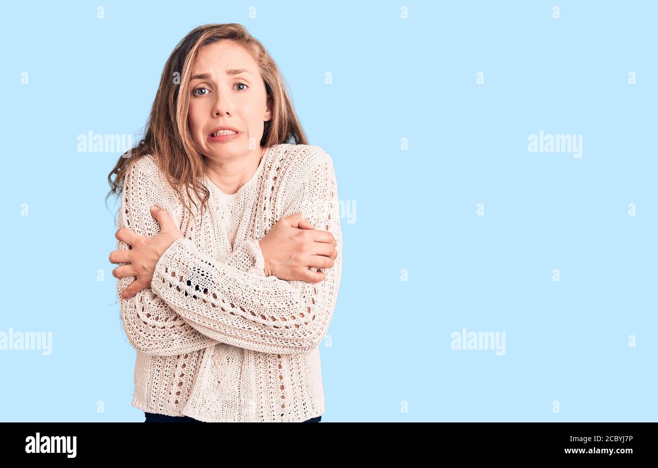 Young beautiful blonde woman wearing casual sweater shaking and ...