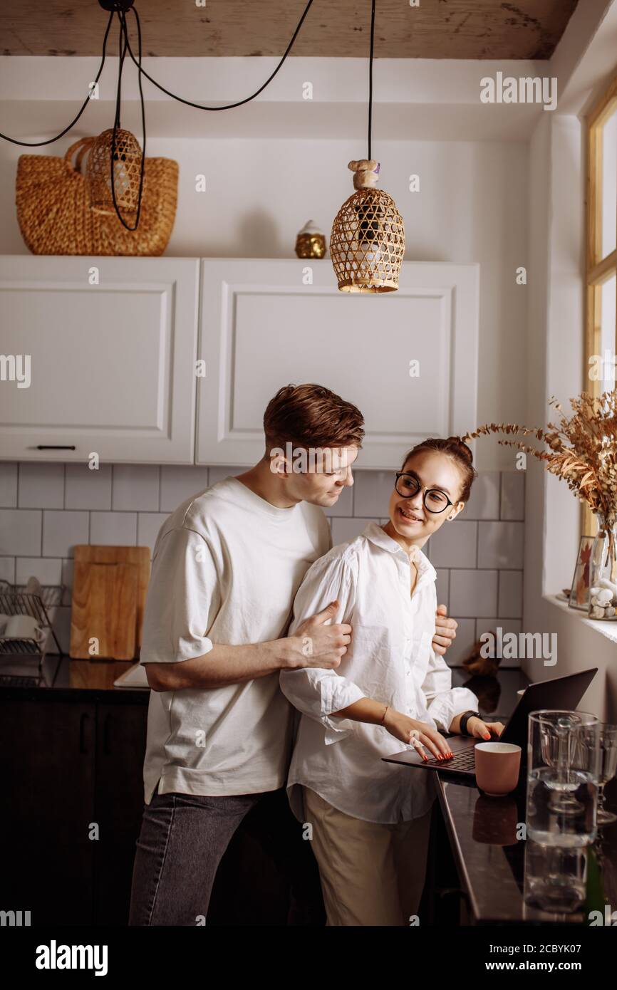 handsome caucasian caring guy support his working wife at home,woman ...