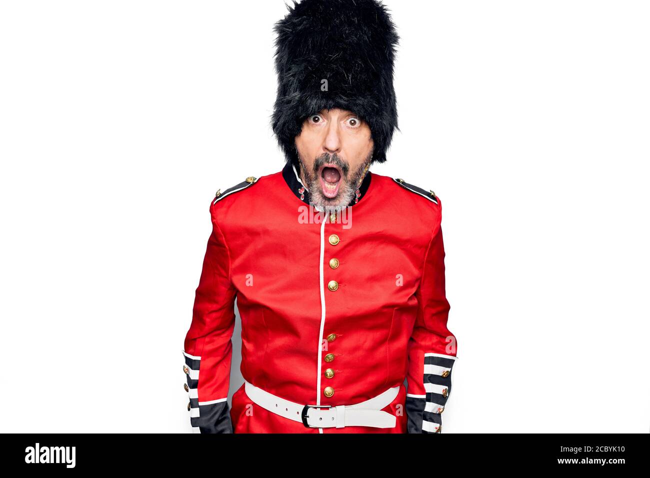 Middle age handsome wales guard man wearing traditional uniform over ...