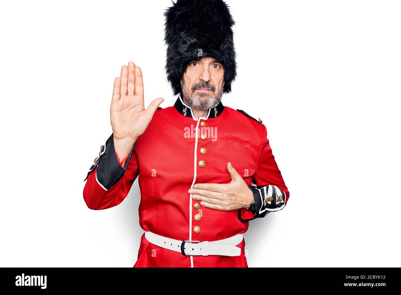 Middle age handsome wales guard man wearing traditional uniform over ...