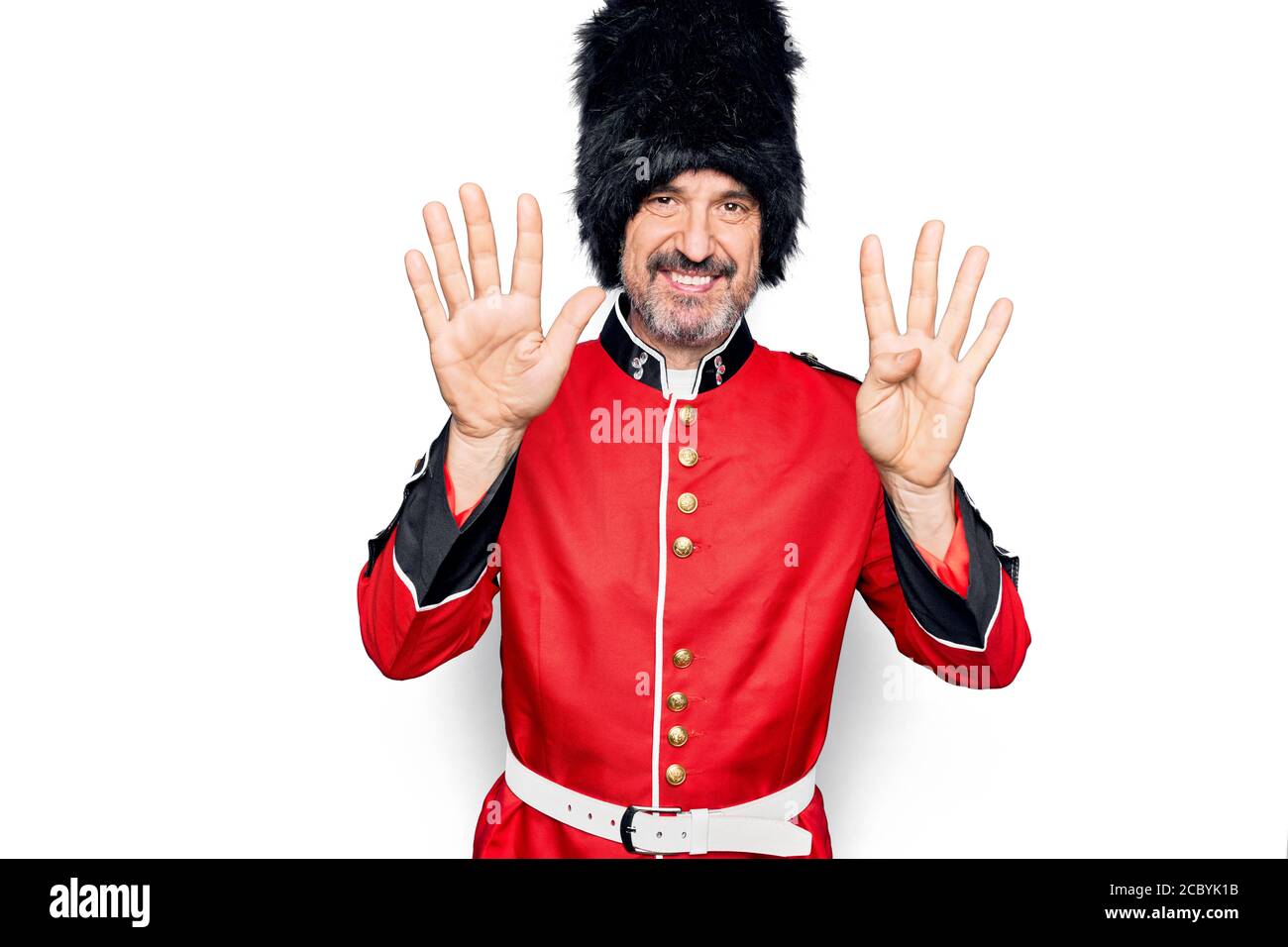 Middle age handsome wales guard man wearing traditional uniform over ...