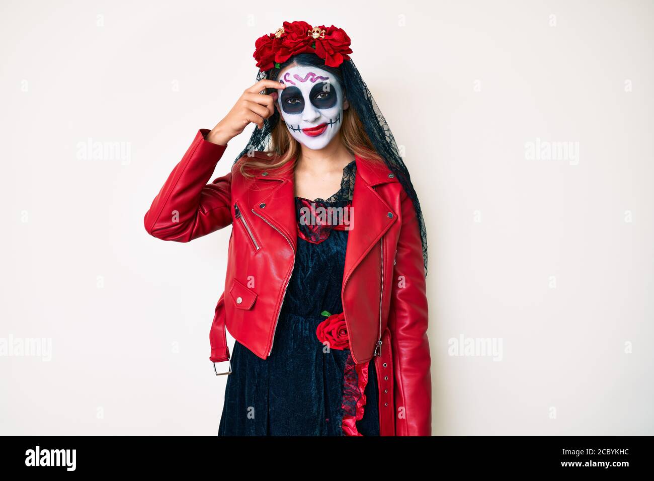 Woman wearing day of the dead costume over white pointing unhappy to ...