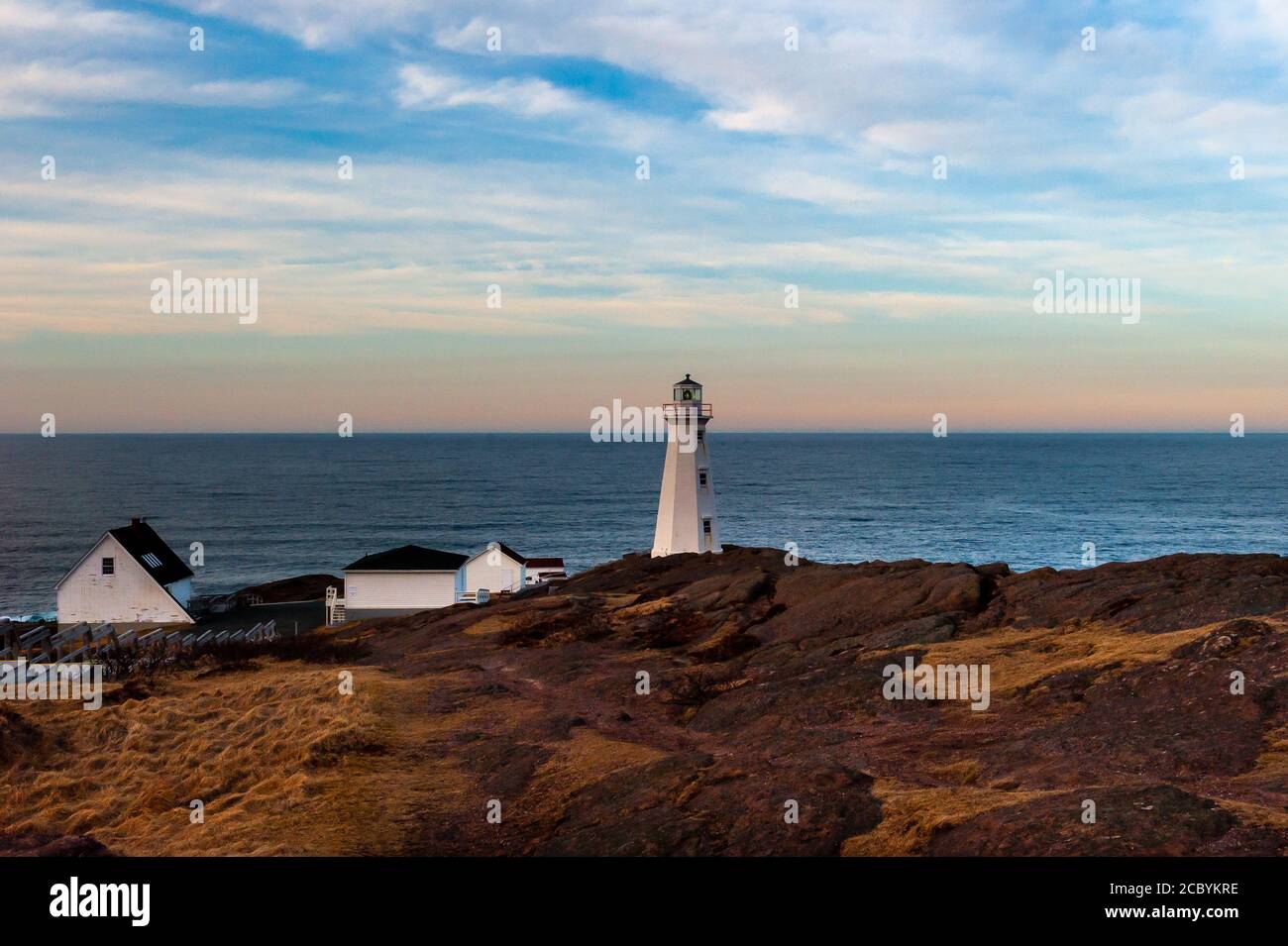 Lighthouse cylinder shape concrete structure on a red rocky cliff with ...