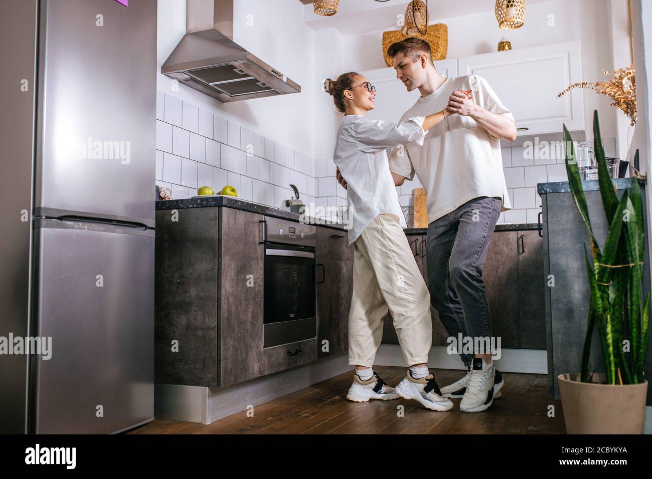 happy young caucasian couple dancing at home, they have harmonious ...