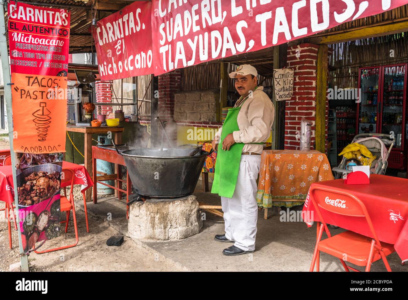 The cook in a small roadside restaurant in San Bartolo Coyetepec stews ...