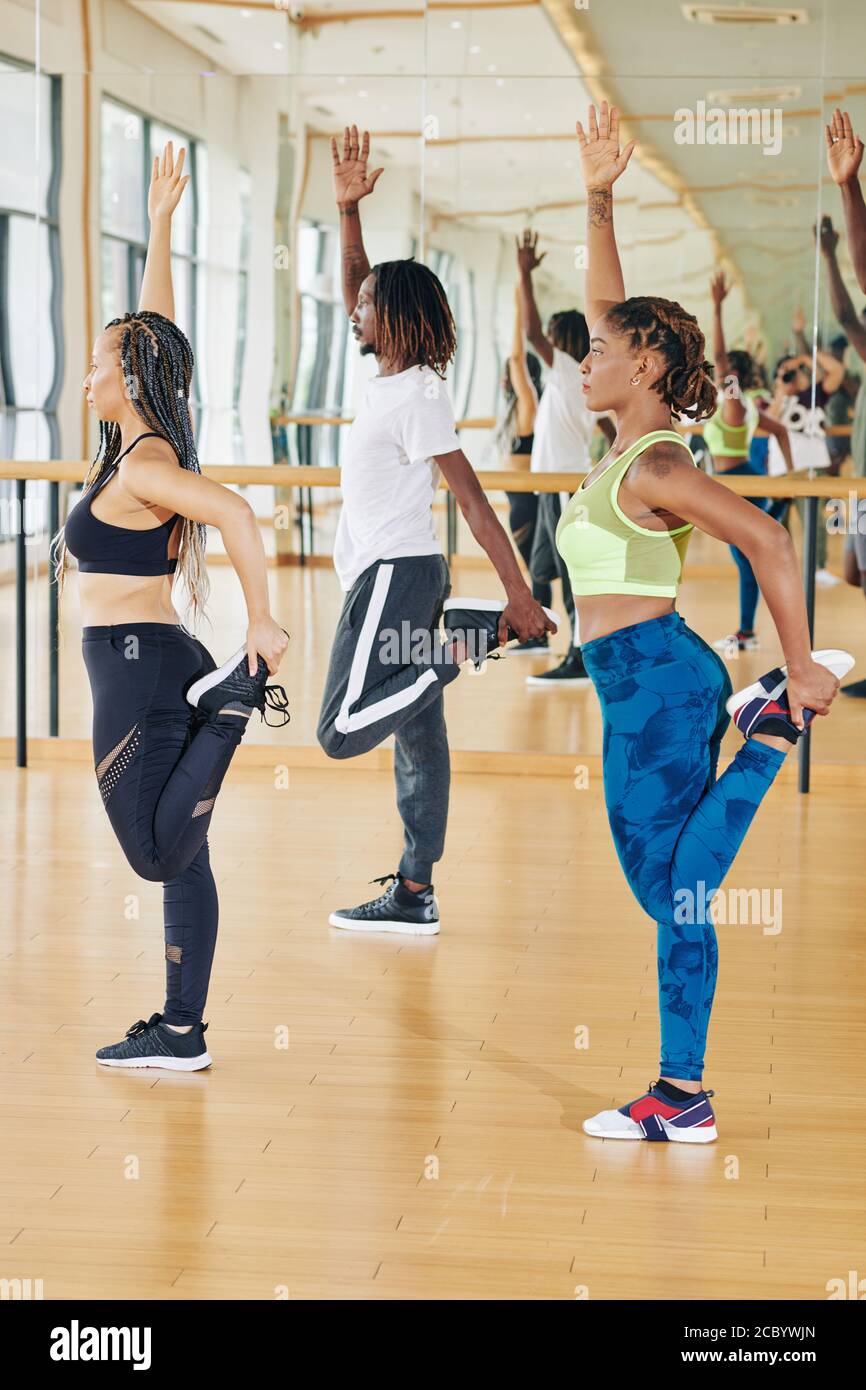 People balancing on one leg Stock Photo - Alamy