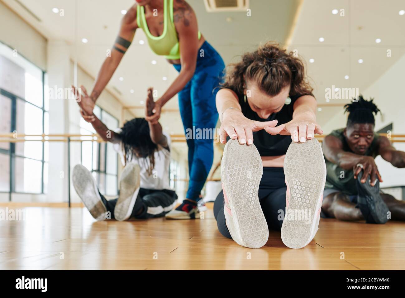 Fit people doing forward fold Stock Photo - Alamy