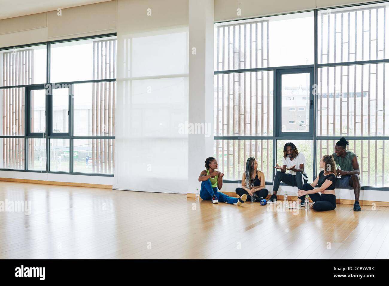Dance coach talking to people Stock Photo - Alamy