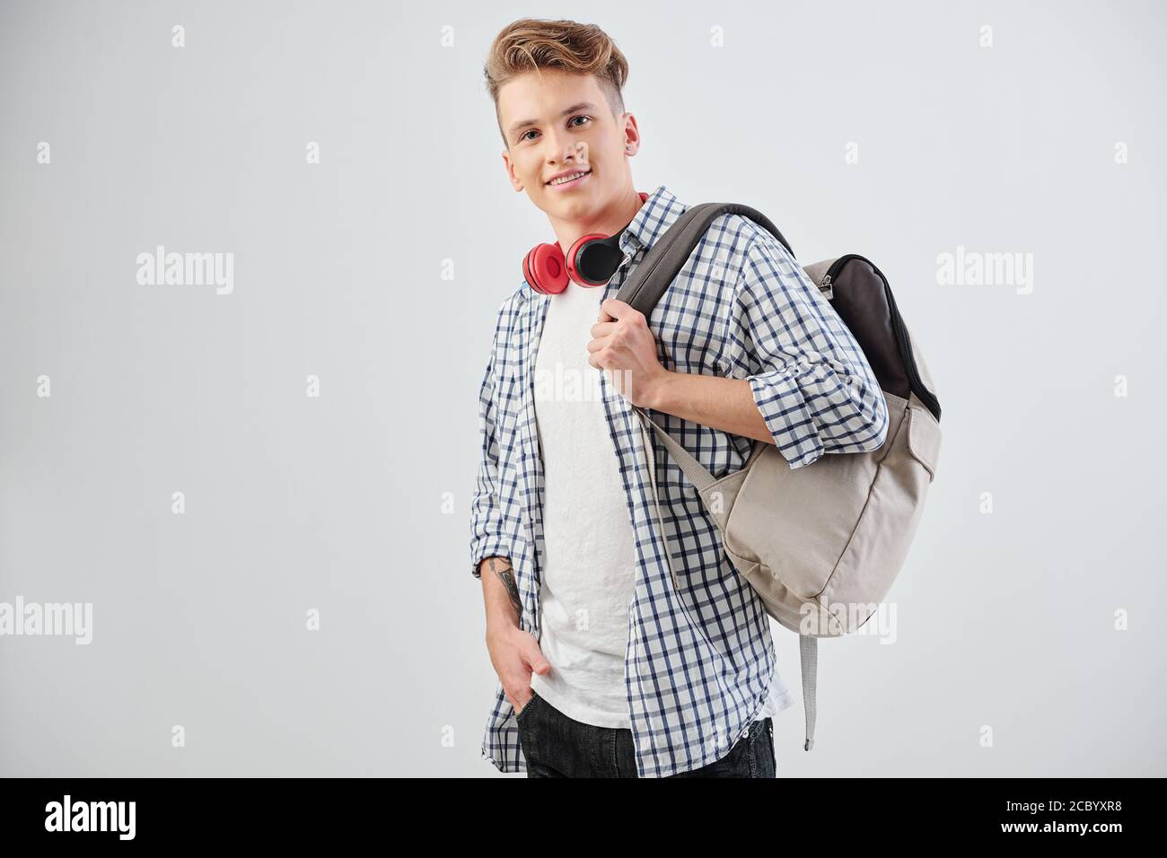 Smiling teenage boy with backpack Stock Photo - Alamy