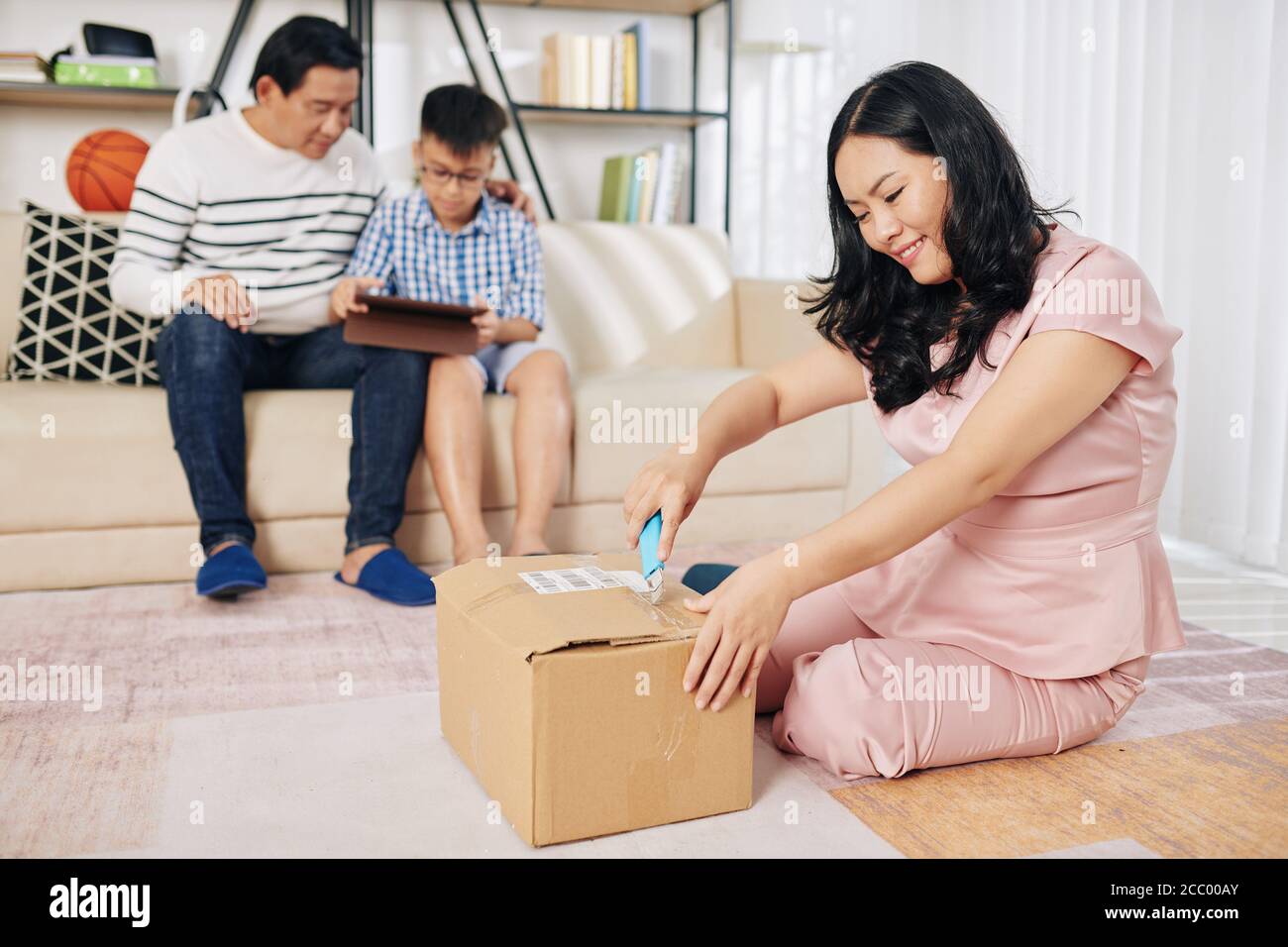 Mature woman opening package hi-res stock photography and images - Alamy