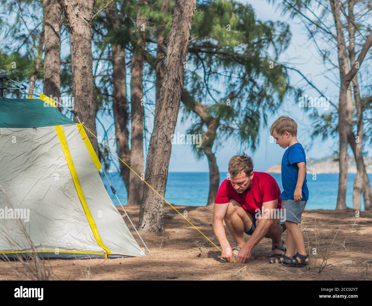 Camping people outdoor lifestyle tourists put up set up green grey ...